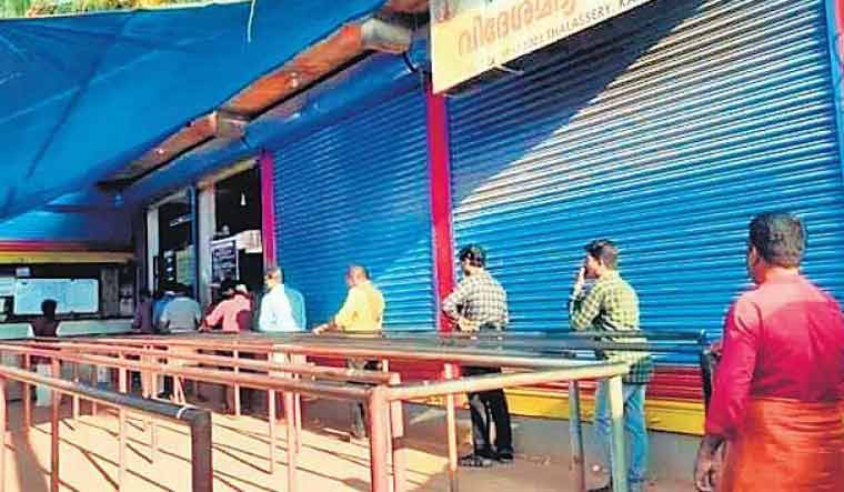 COVID-19: Social distancing seen outside Kerala beverage shops- The Week