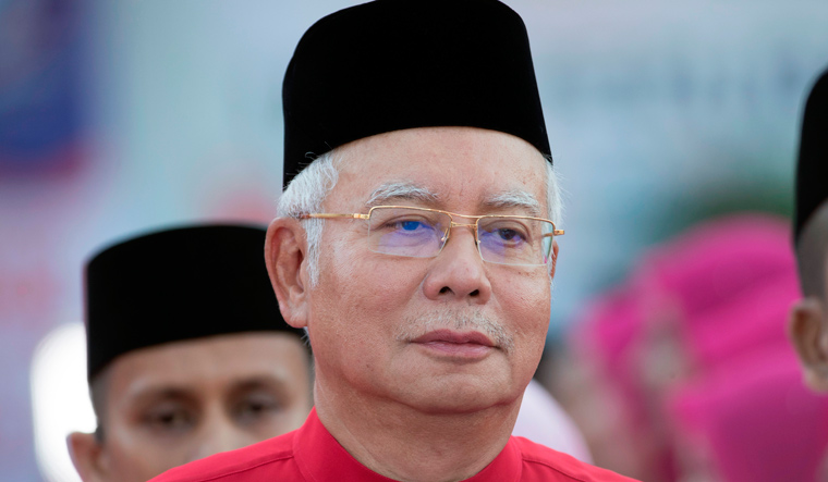 Ex-Malaysian PM Razak, wife banned from leaving country- The Week